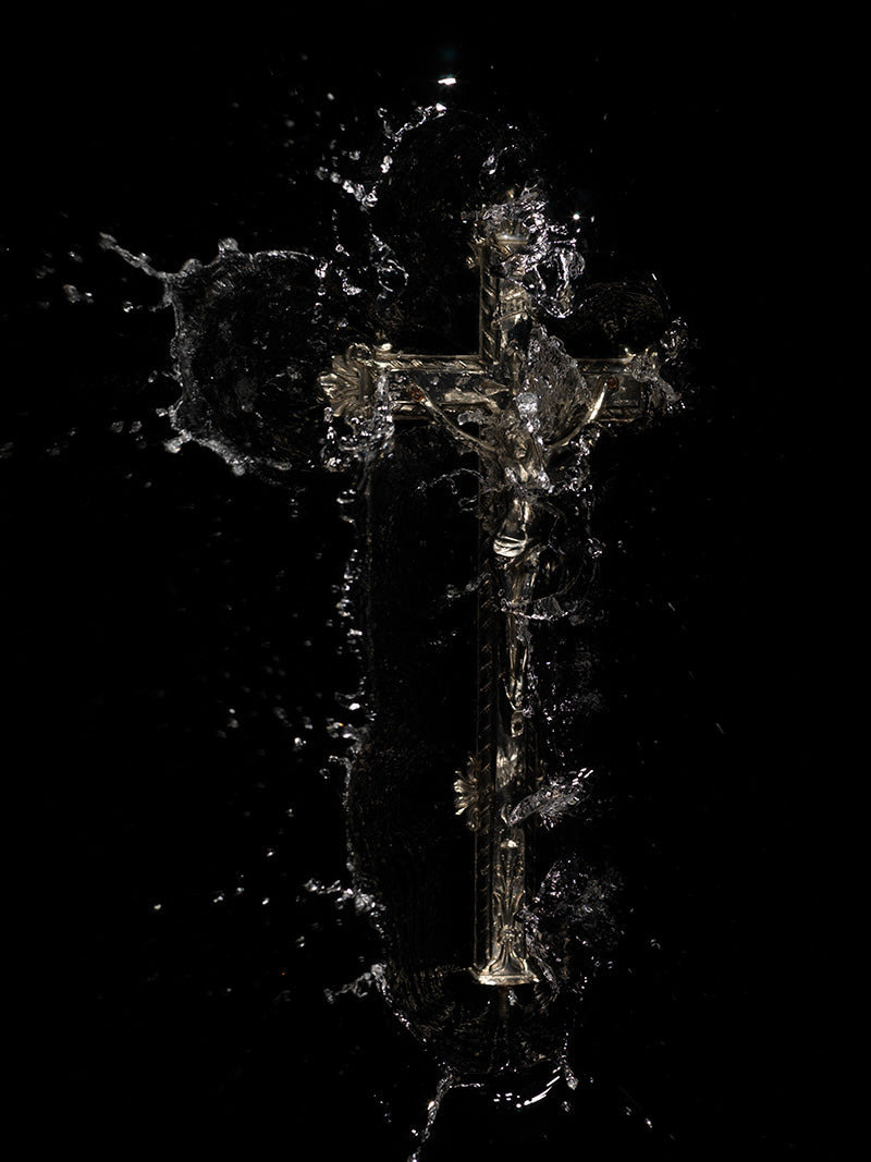 splash crucifixion cross is cast into water recreating a catholic reli ...